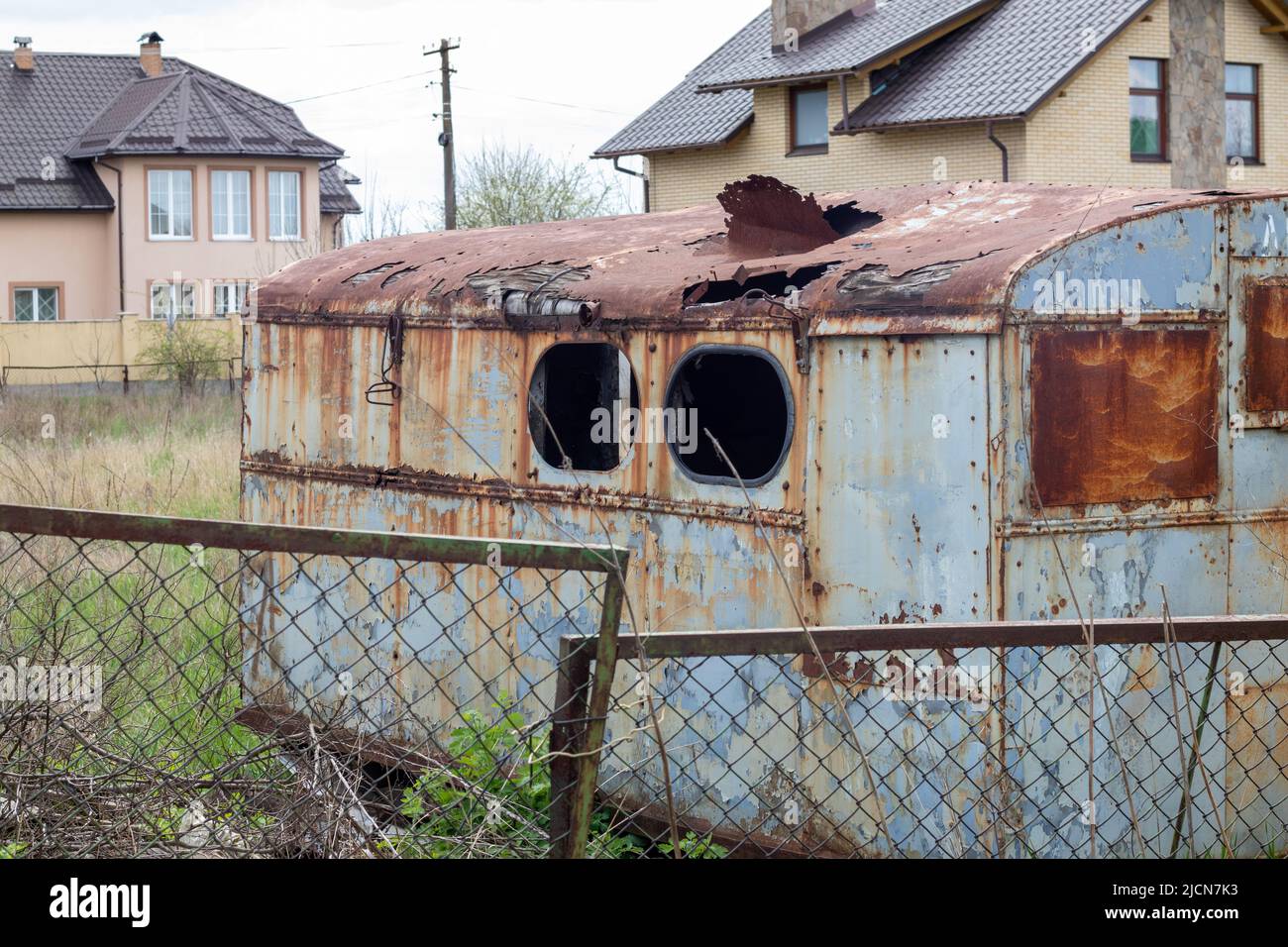 A dilapidated rotten and rusty metal hut on a work site. An old tin ...
