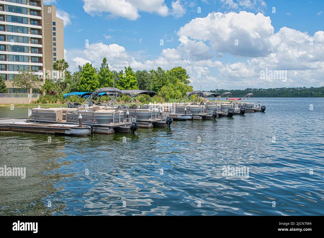 Poontoon style boats moored at a dock Stock Photo - Alamy