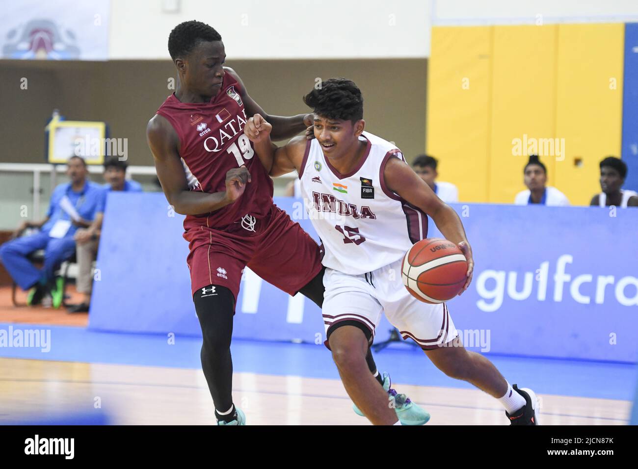 Doha, Qatar. 14th June, 2022. Moustapha Ndao (L) of Qatar Basketball team and Sanju Gajbhiye of ...