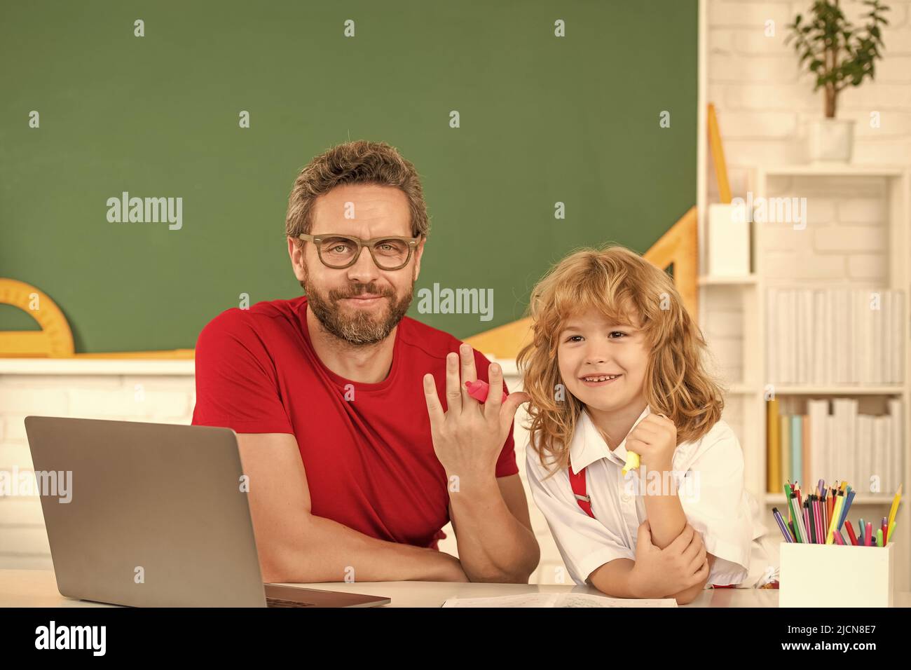 online education on laptop. father and son use modern communication ...