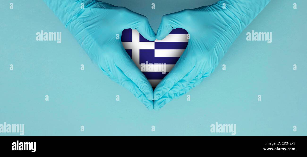 Doctors hands wearing blue surgical gloves making hear shape symbol ...