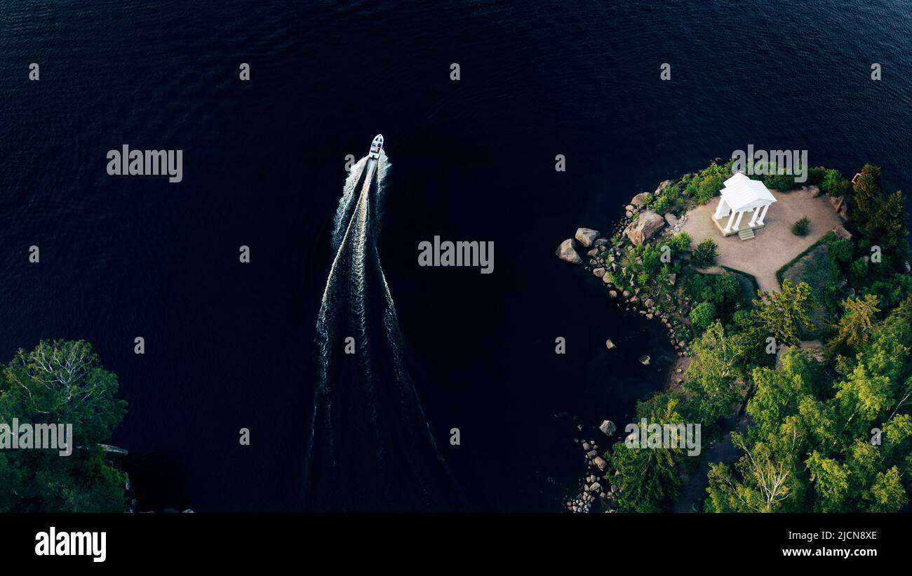 Top view of a white boat sailing in the blue sea. Top view of the boat ...