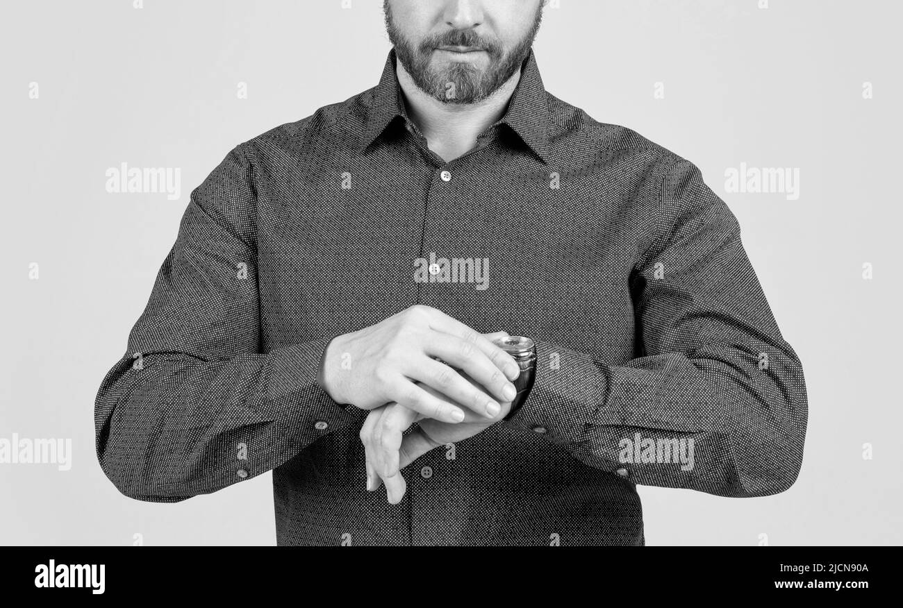 Bearded man cropped view in casual shirt check time on watch grey ...