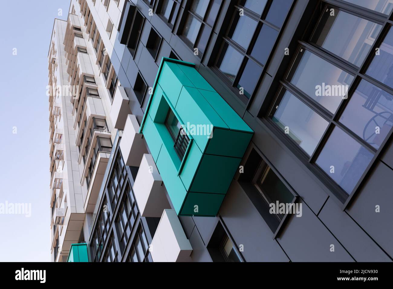 facade of a strong multi-family residential building with emerald color ...