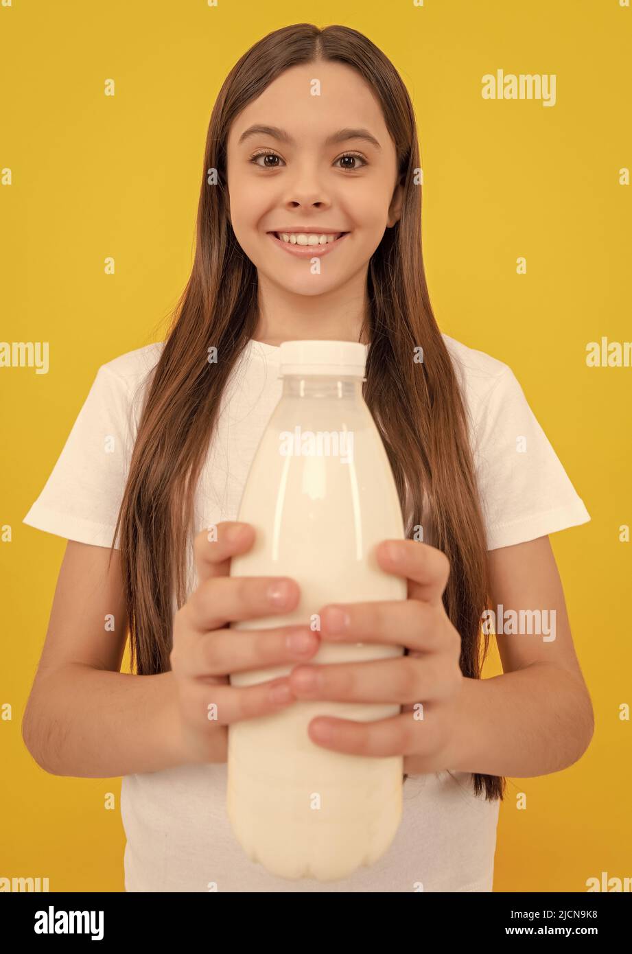 milk bottle in hand of cheerful child. kid hold dairy beverage product ...