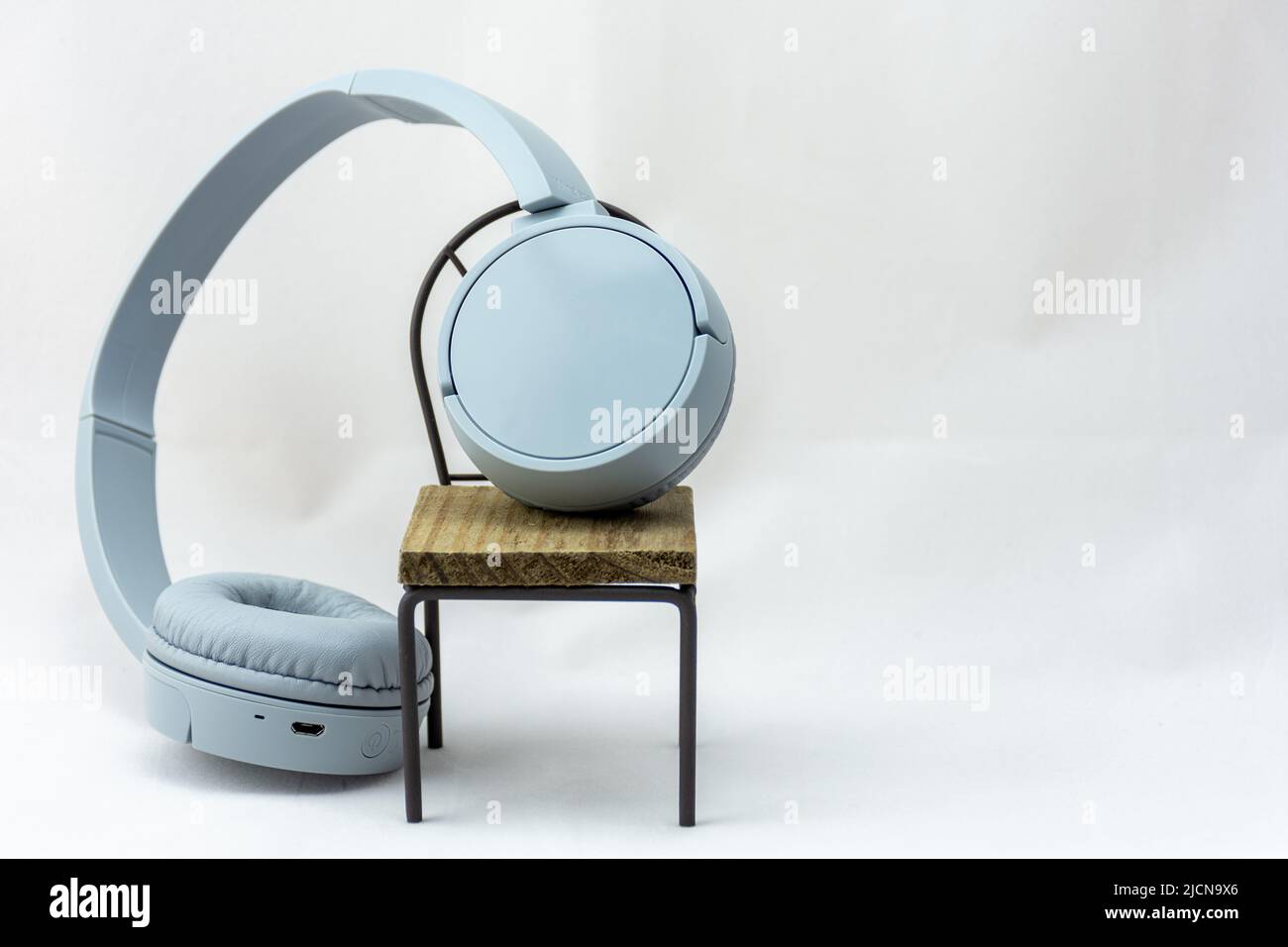 Close-up wireless headset on little chair isolated on white background ...