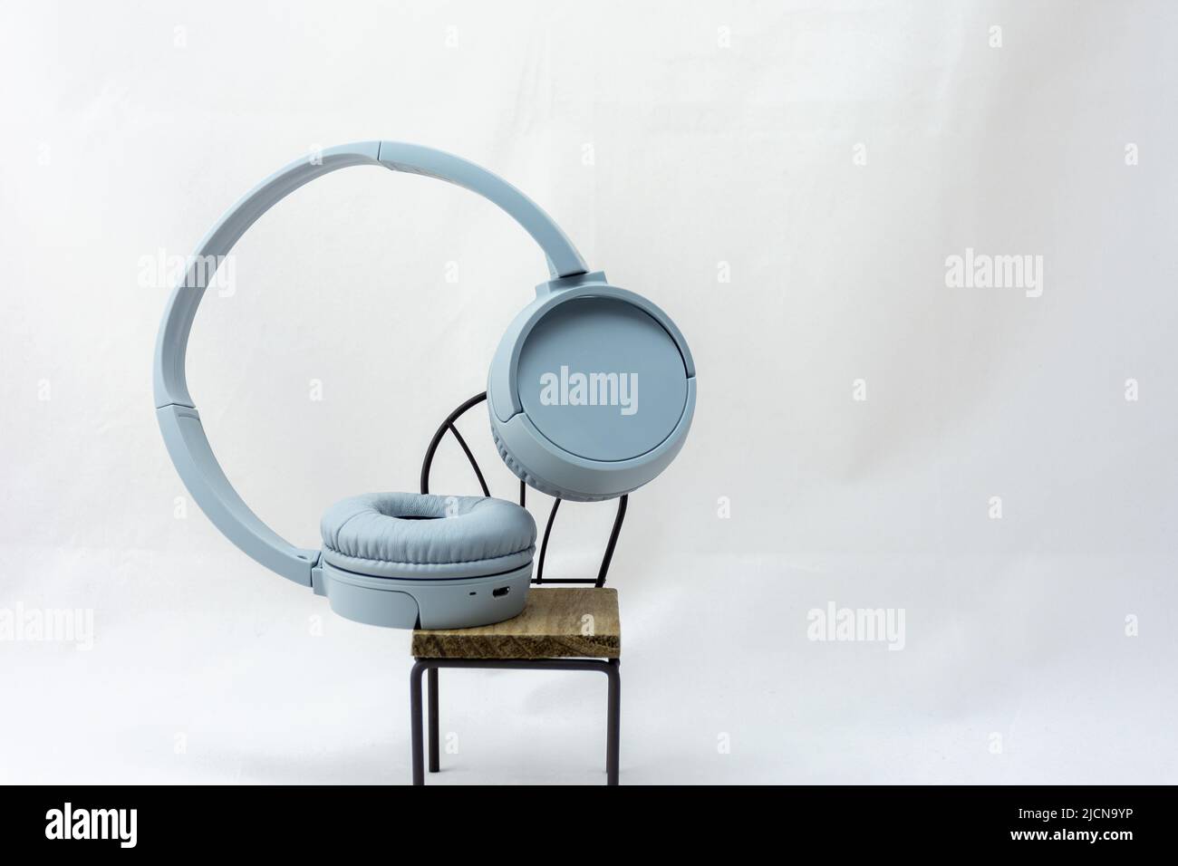 Close-up wireless headset on little chair isolated on white background ...