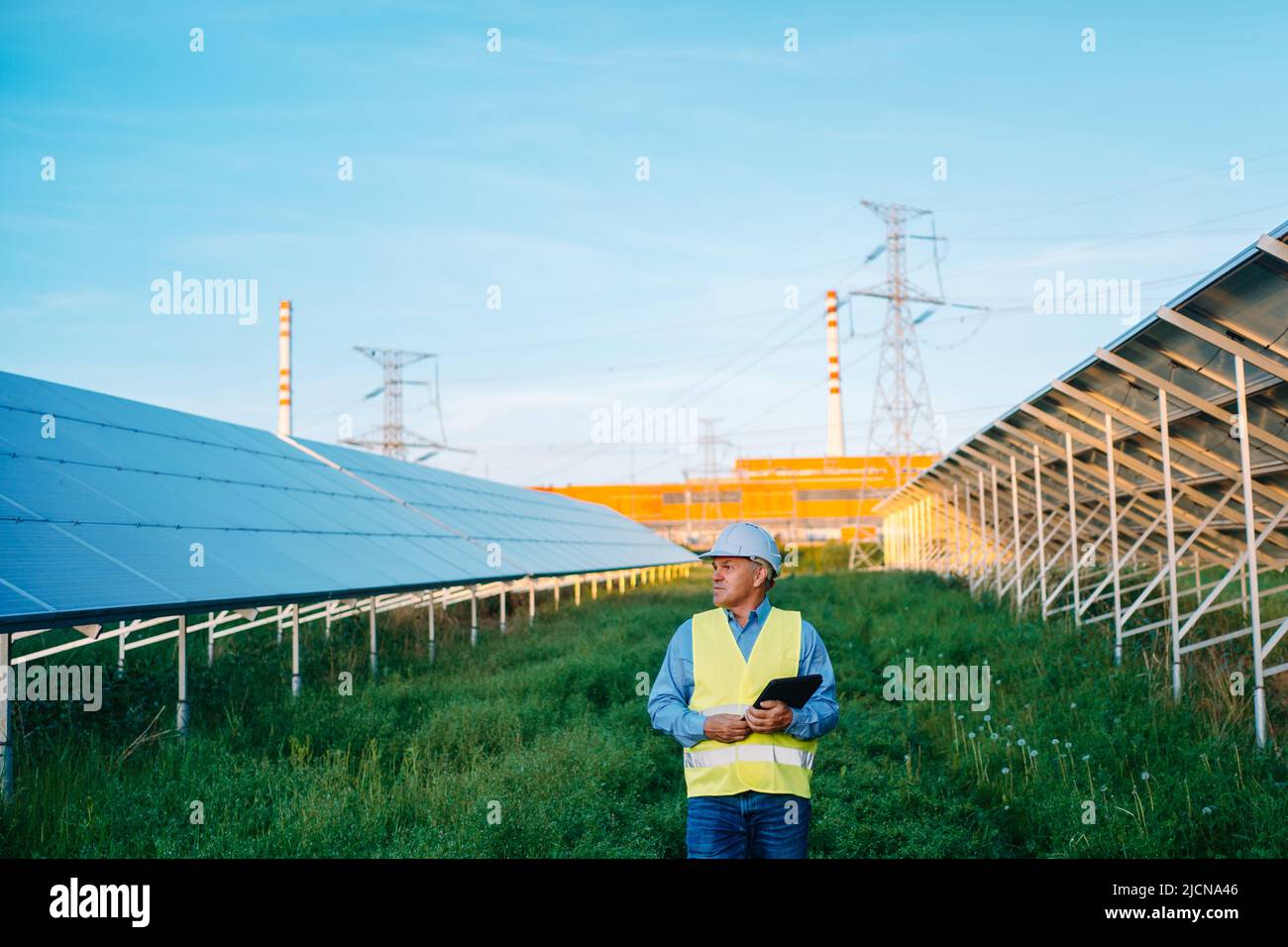 Solar engineer walking in solar farm. Alternative Eco energy concept ...