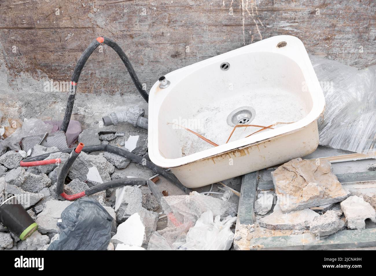 a denied dismantled old metal kitchen sink washbasin thrown into a ...