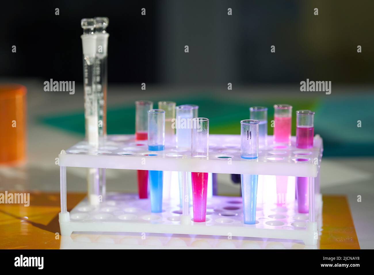 Solution in a scientific glass flask against the background of a school ...