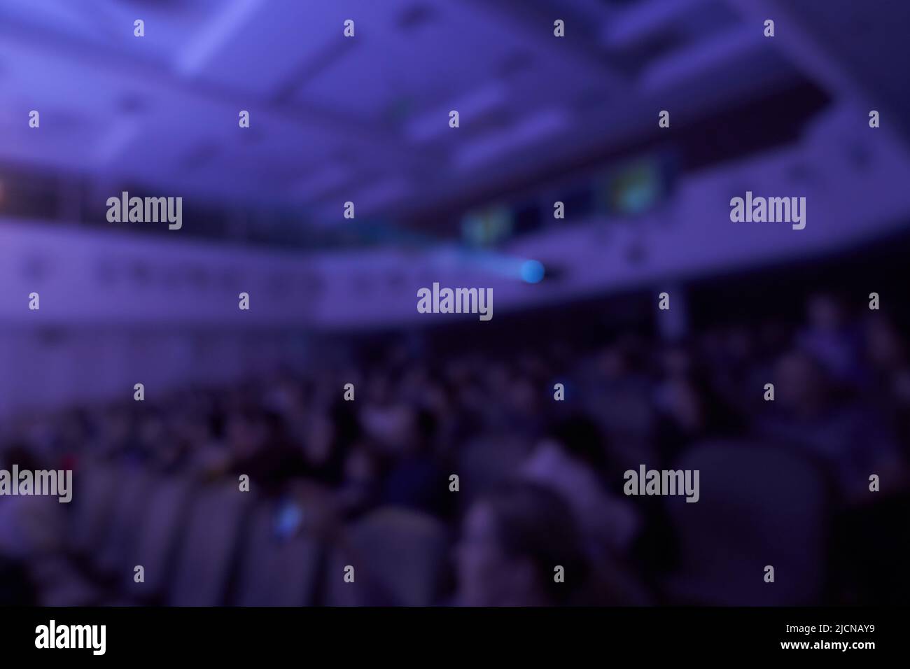 Event hall with chairs on a blurry background. The audience of a music ...