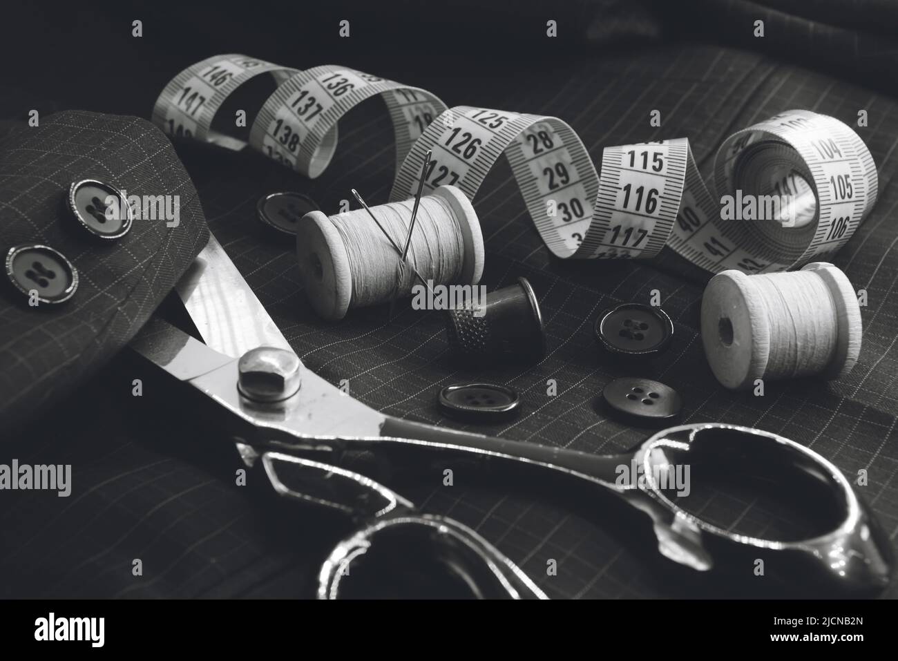 Retro tools for cutting and sewing. Needle with thread, thimble, sewing ...