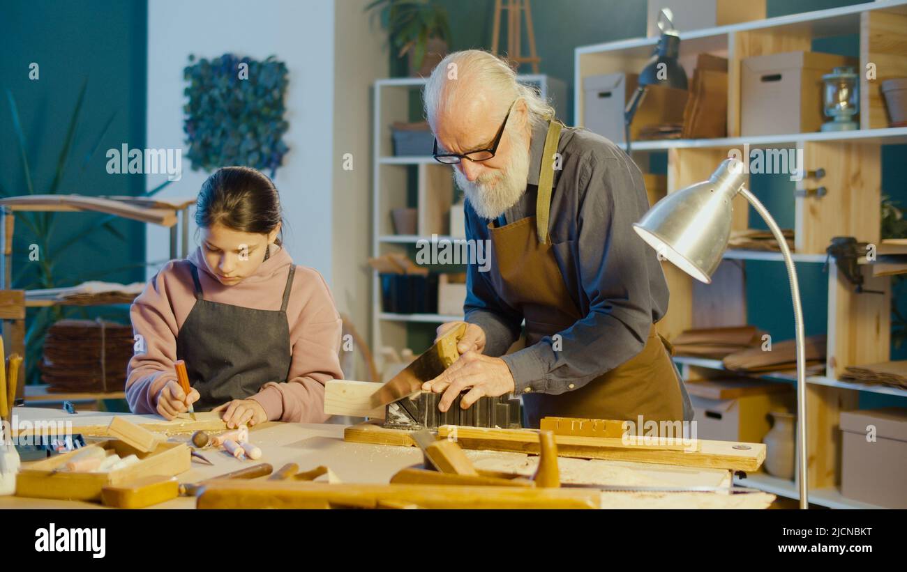 Grandfather Carpenter with Granddaughter Work with Wood to Create Items ...