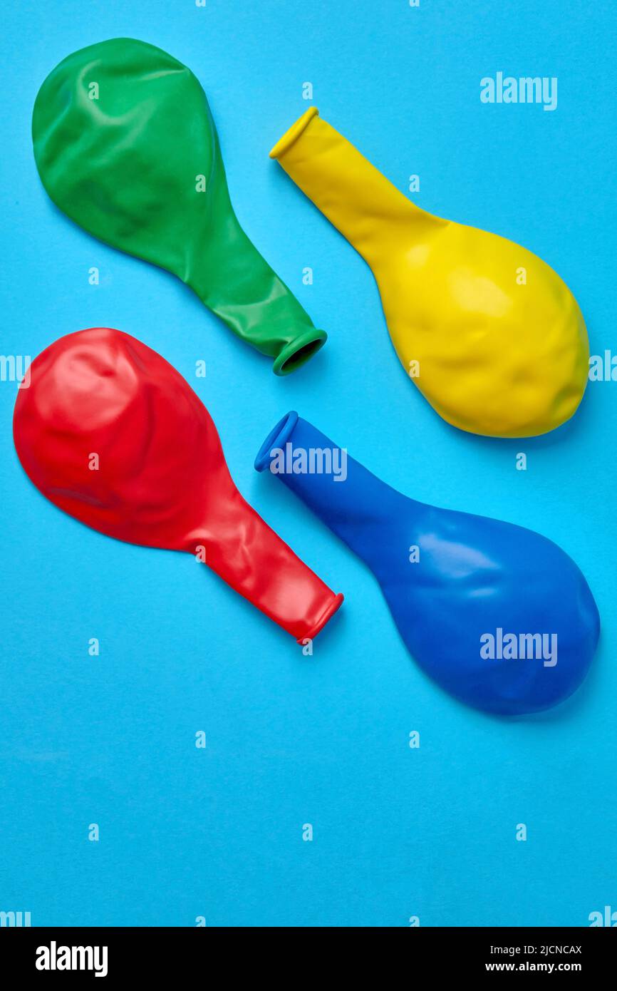 Multi-colored not inflated balloons red, yellow, blue, green lie ...