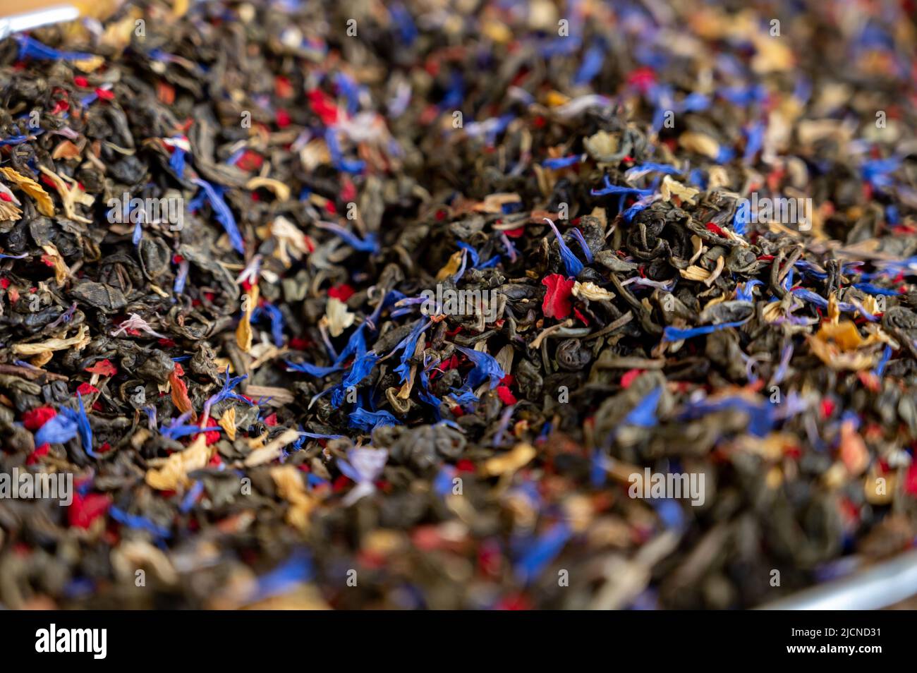 Blended black leaf dry tea with aromatic flowers, spices in tea shop in ...