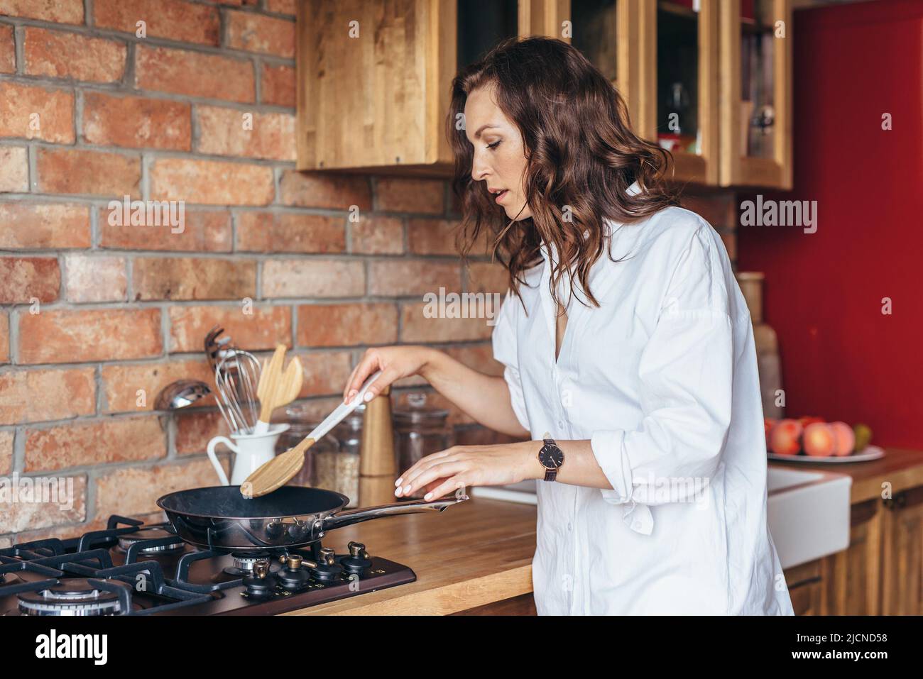 Woman stirring at stove hi-res stock photography and images - Alamy