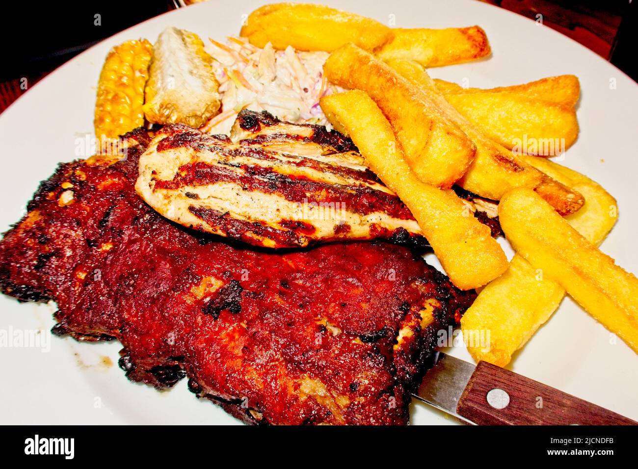 Chicken and chips served with ribs Stock Photo - Alamy