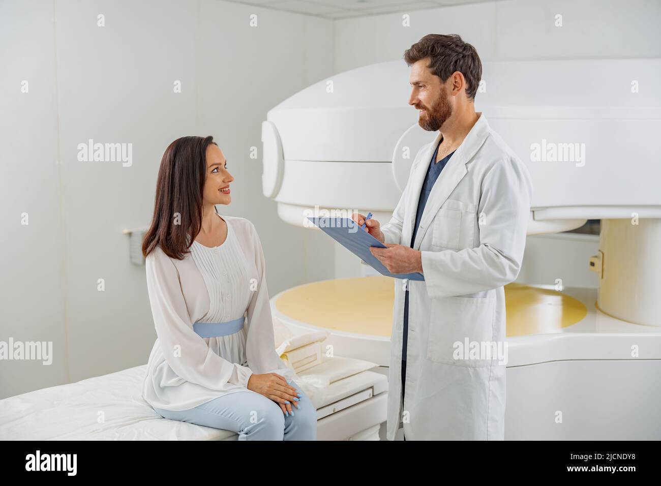 Woman patient talking with doctor radiologist before MRI or CT scan in ...