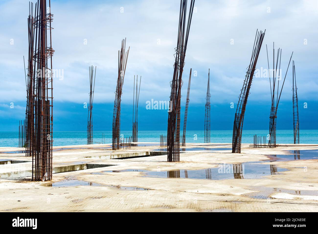 unfinished building with protruding rebar on the seashore Stock Photo ...