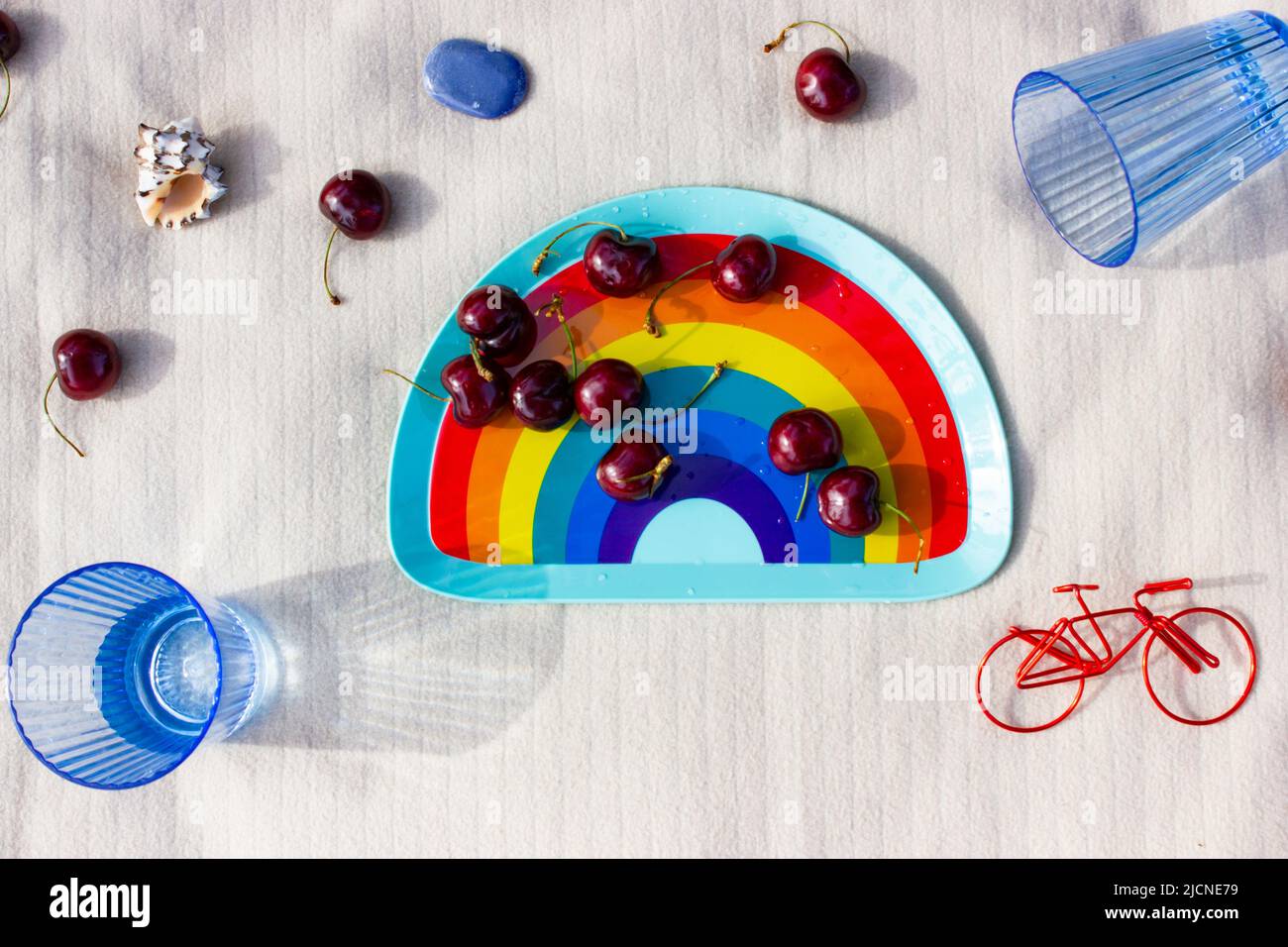 LGBTQ picnic in summer. Plaid with LGBT tableware, blue glasses. Pride ...