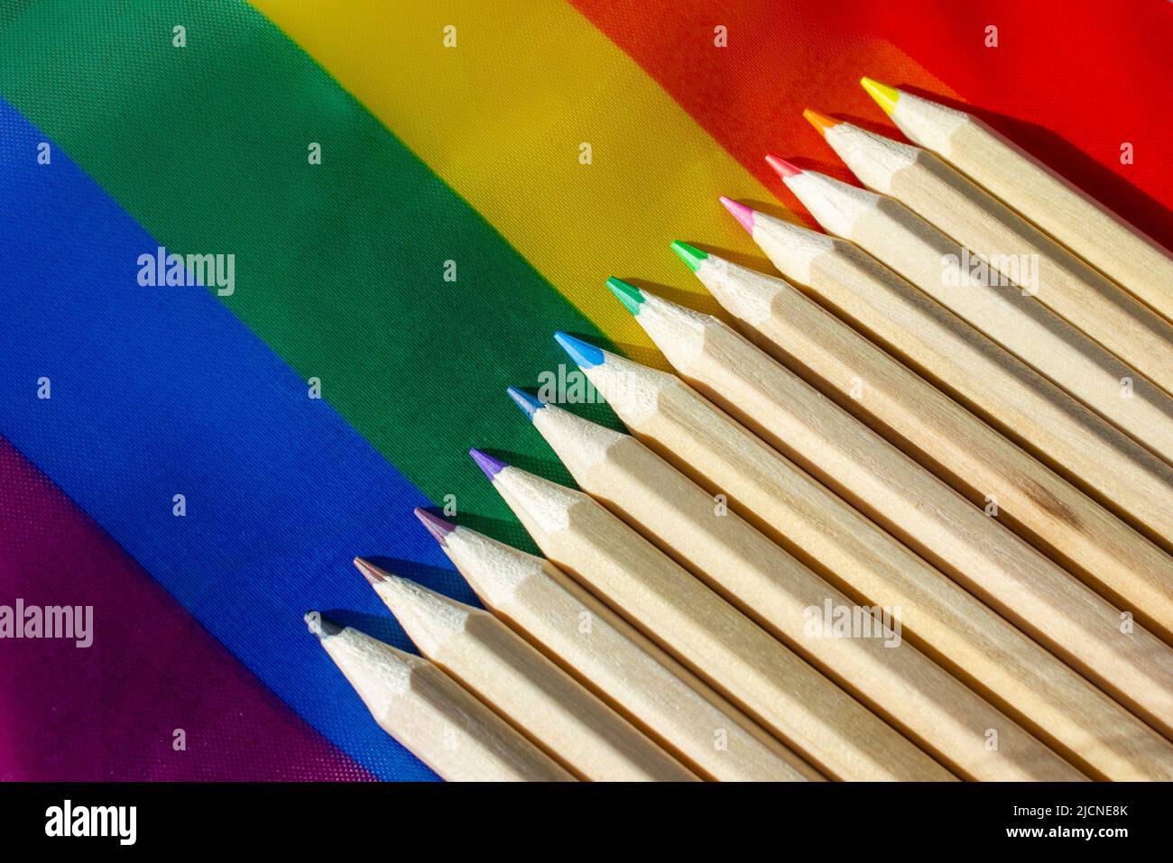 Multicolored pencils on rainbow abstract background. Drawing tools ...