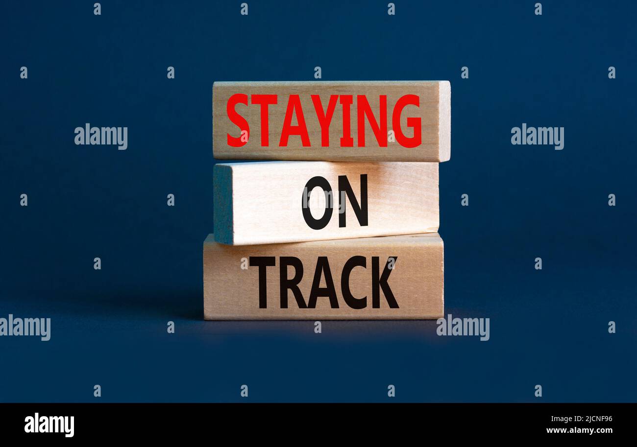 Staying on track symbol. Concept words Staying on track on wooden ...