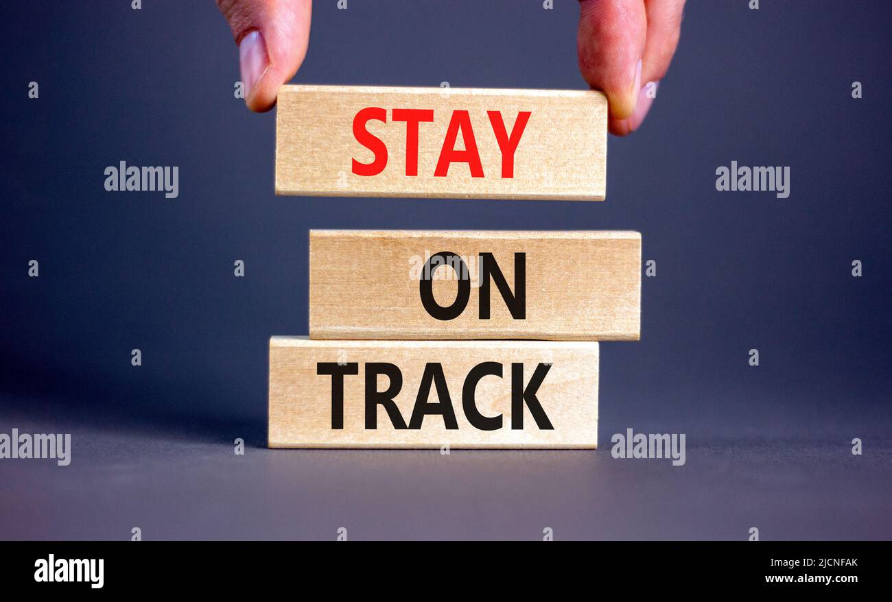 Stay on track symbol. Concept words Stay on track on wooden blocks on a ...
