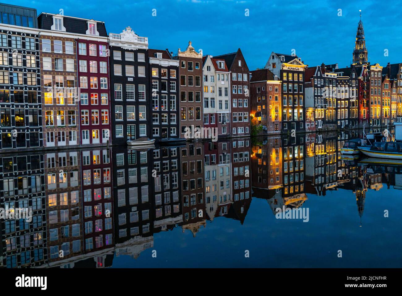 Canal houses on the Damrak, in the centre of the old town of Amsterdam ...