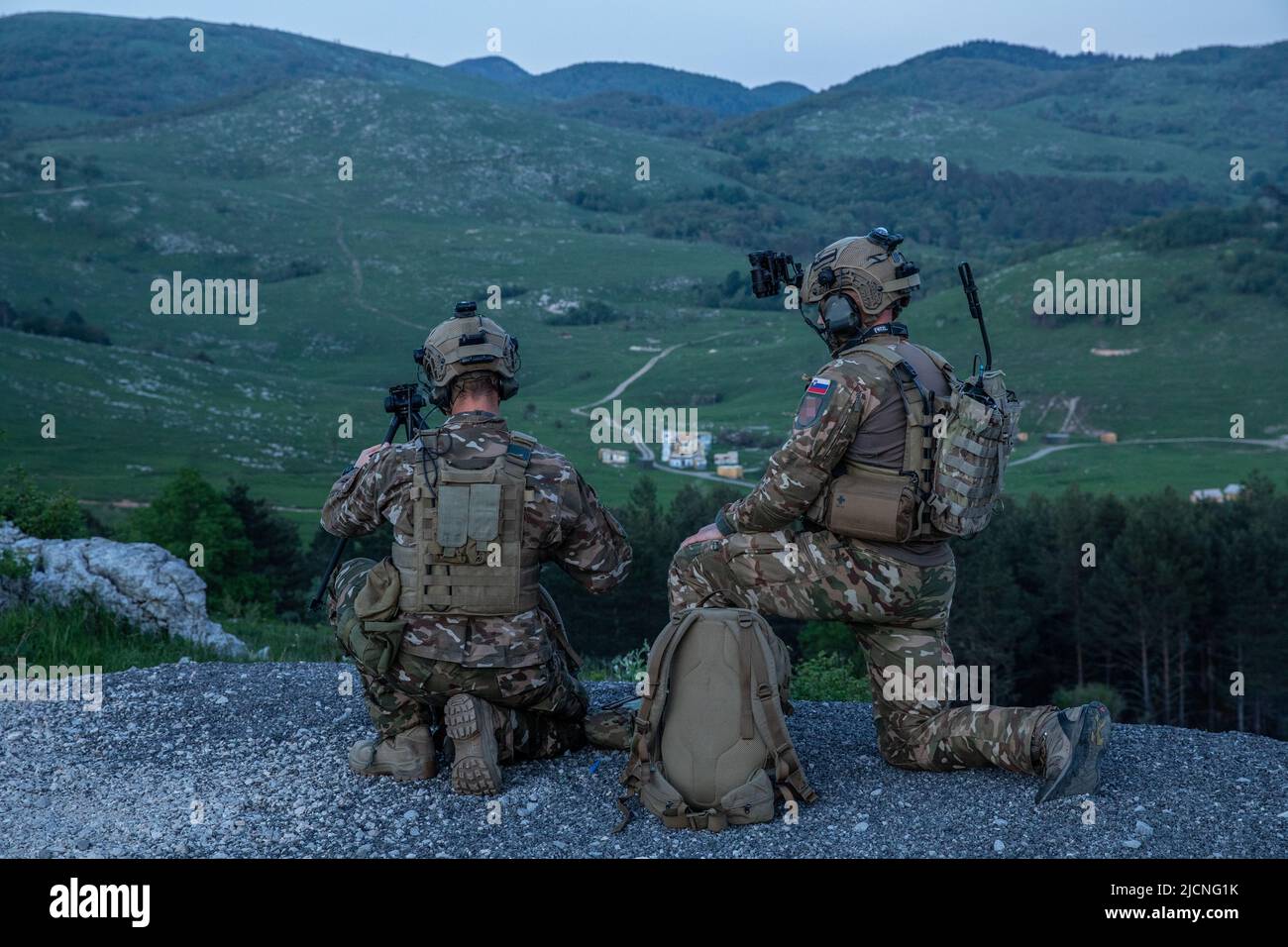 Slovenian Special Operations Forces (SOF) members set up a rangefinder ...