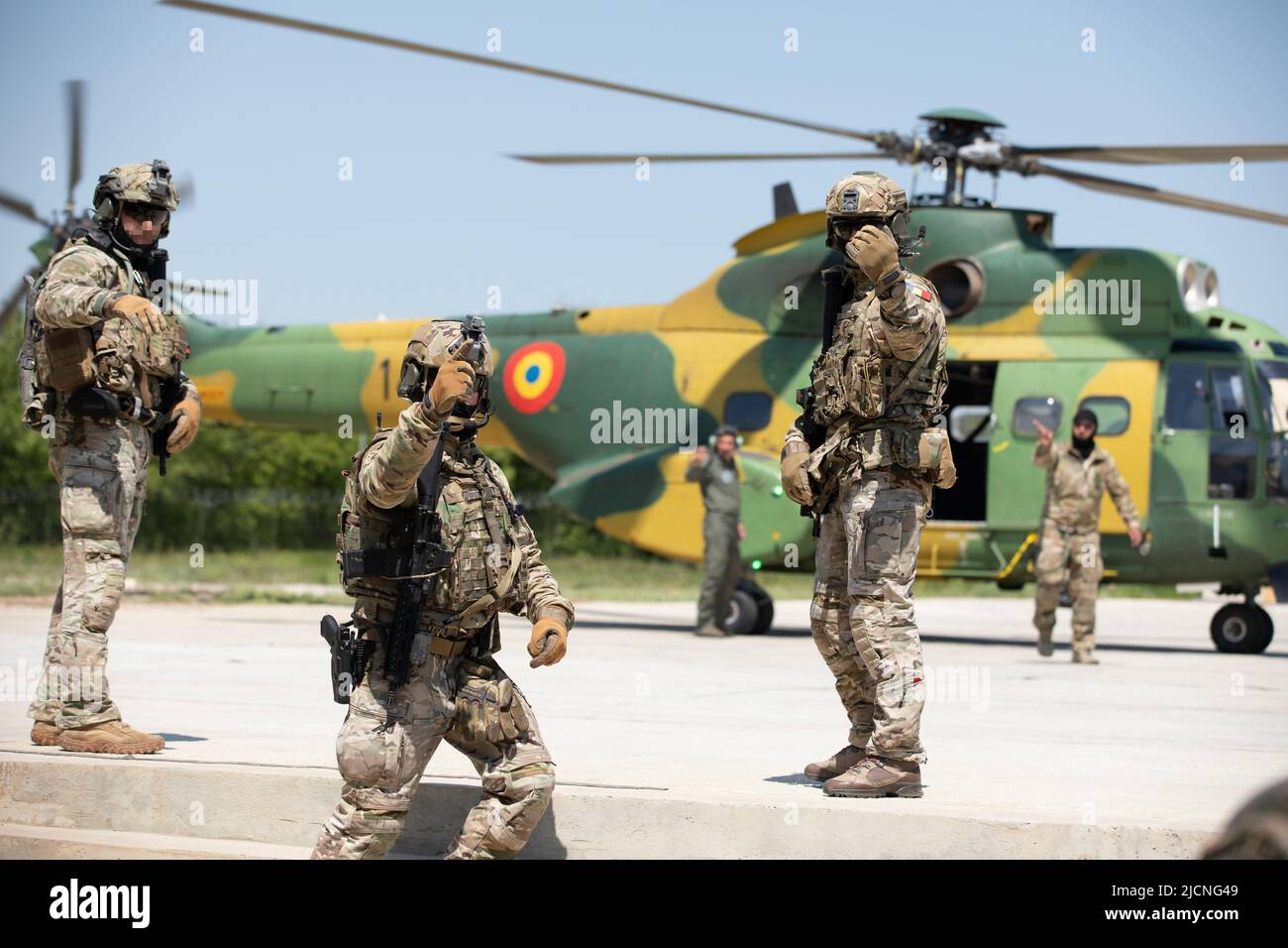 Members of Romanian Naval Special Operations Forces (NAVSOF) signal the ...