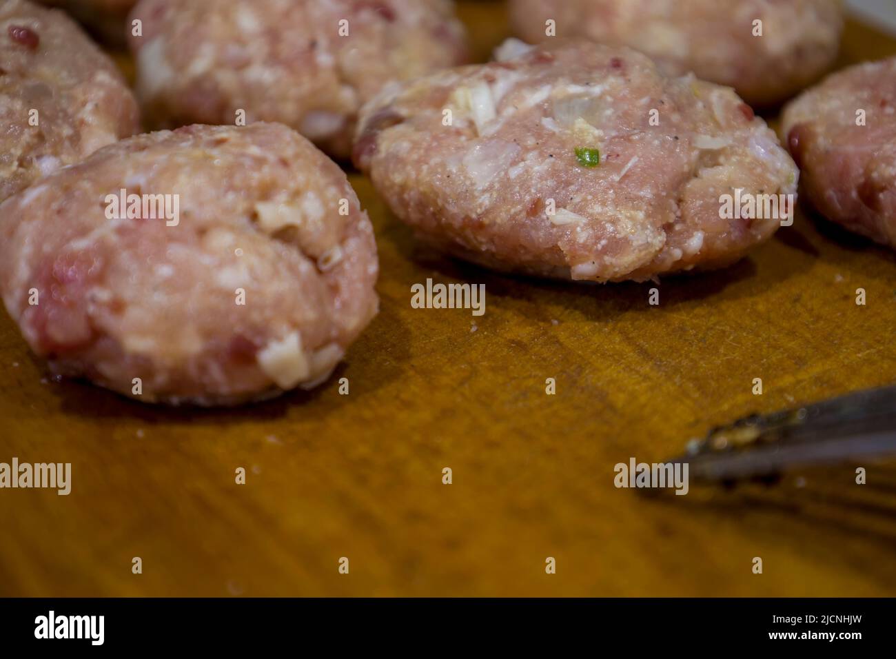 Raw meatballs on the board Stock Photo - Alamy