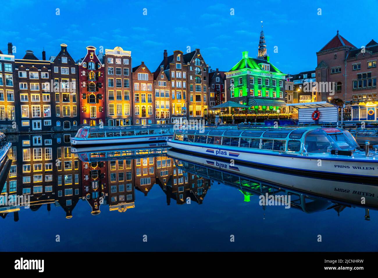 Canal houses on the Damrak, in the centre of the old town of Amsterdam ...