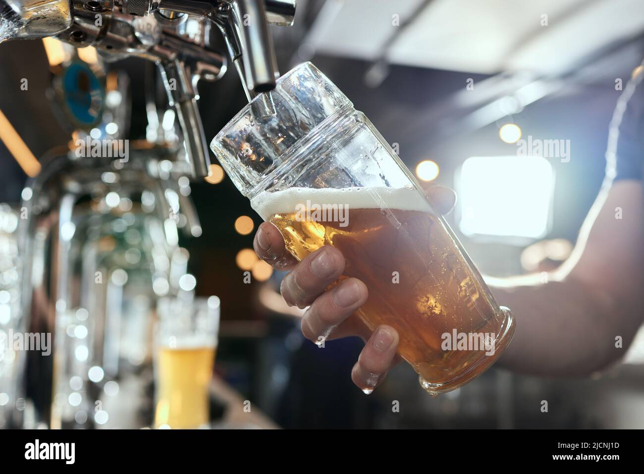 Pouring Beer Into A Mug In A Beer Bar Close Up Beer Bottling In The
