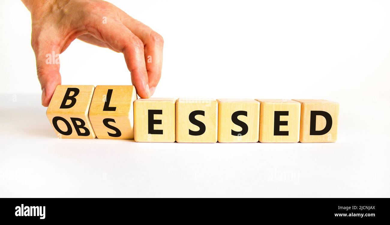Blessed or obsessed symbol. Businessman turns wooden cubes and changes ...