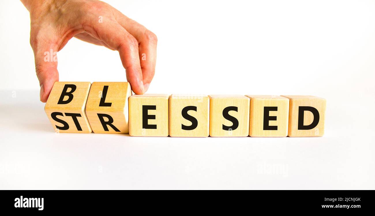 Blessed or stressed symbol. Businessman turns wooden cubes and changes ...
