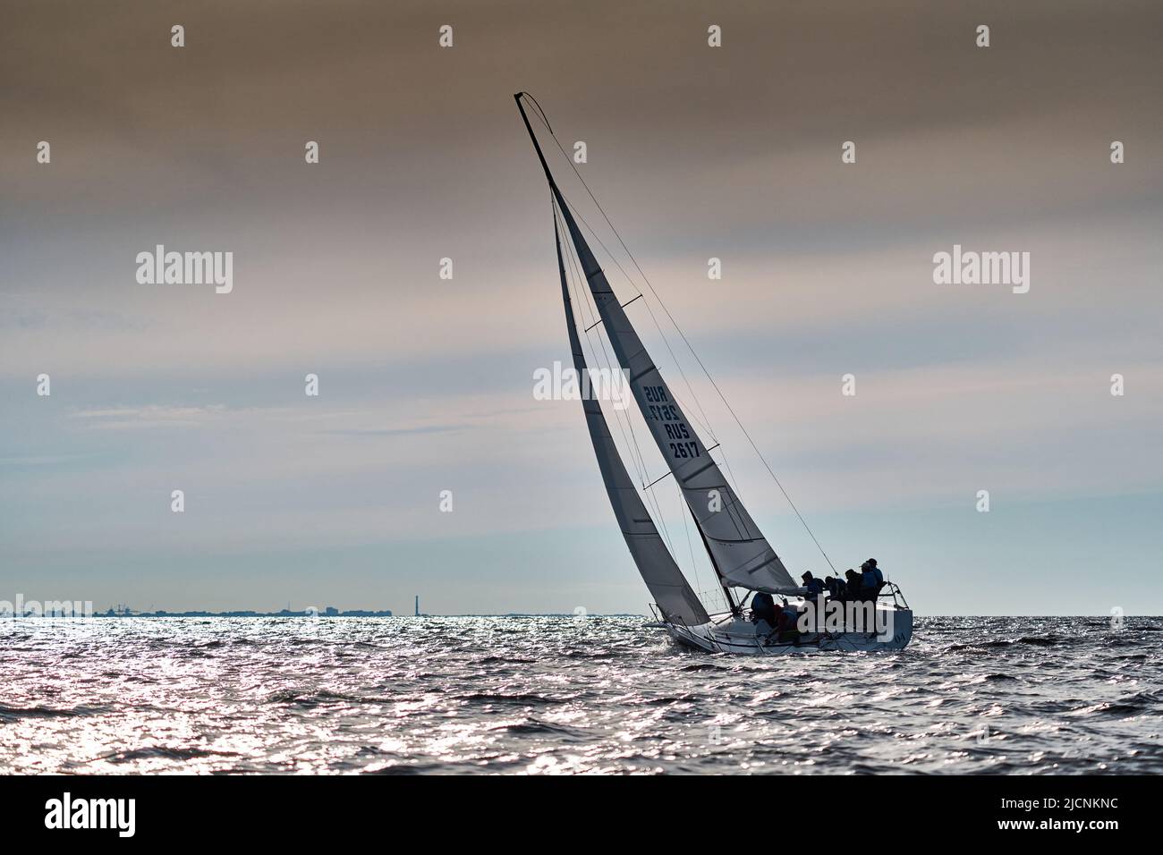 Russia, St. Petersburg, 10 June 2022: Sailboat in sea at sunset, orange ...