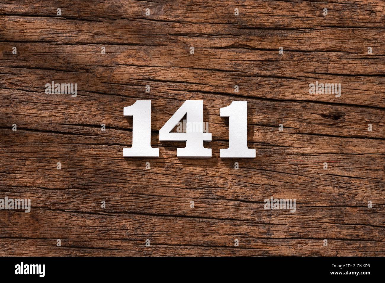 Number 141 - piece on rustic wood background Stock Photo - Alamy
