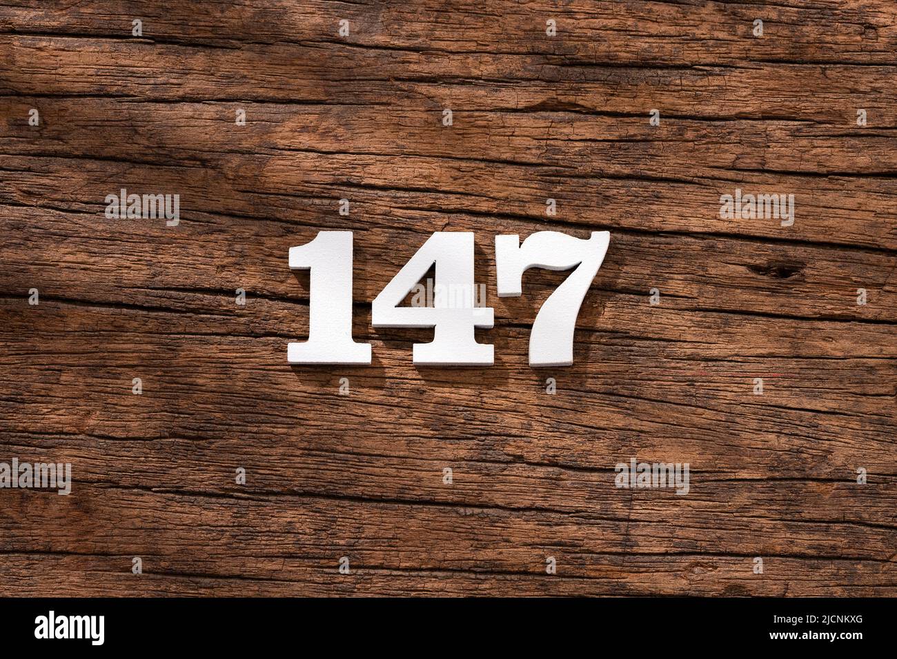 Number 147 - piece on rustic wood background Stock Photo - Alamy