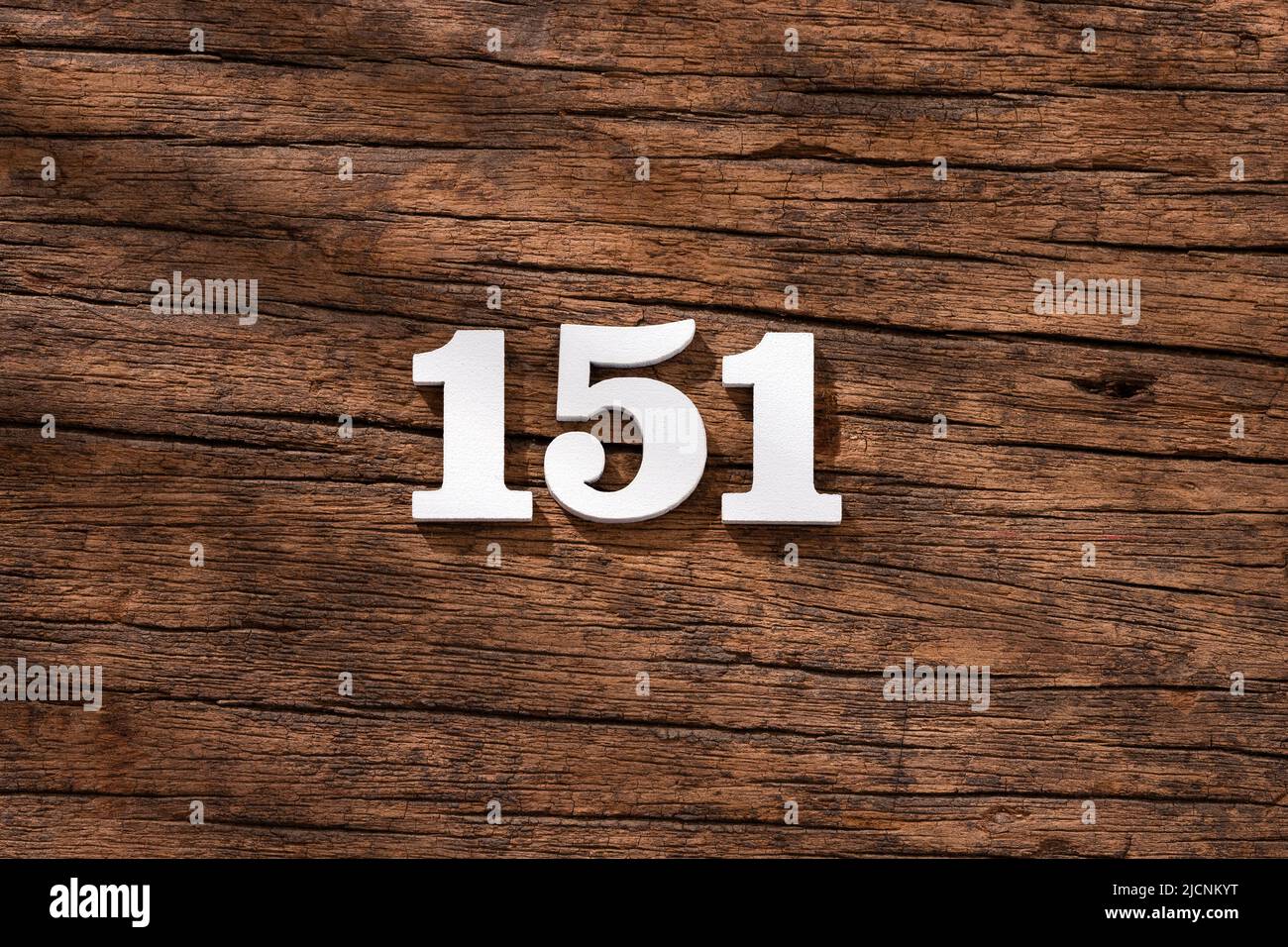 Number 151 - piece on rustic wood background Stock Photo - Alamy