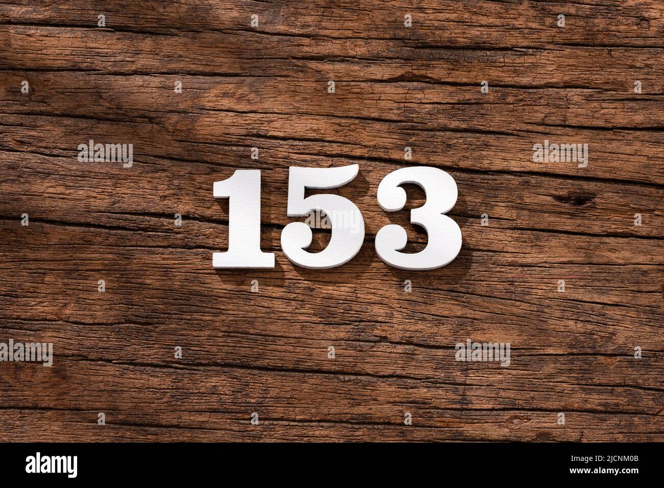 Number 153 - piece on rustic wood background Stock Photo - Alamy
