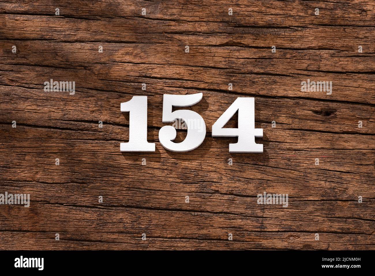 Number 154 in wood, isolated on rustic background Stock Photo - Alamy