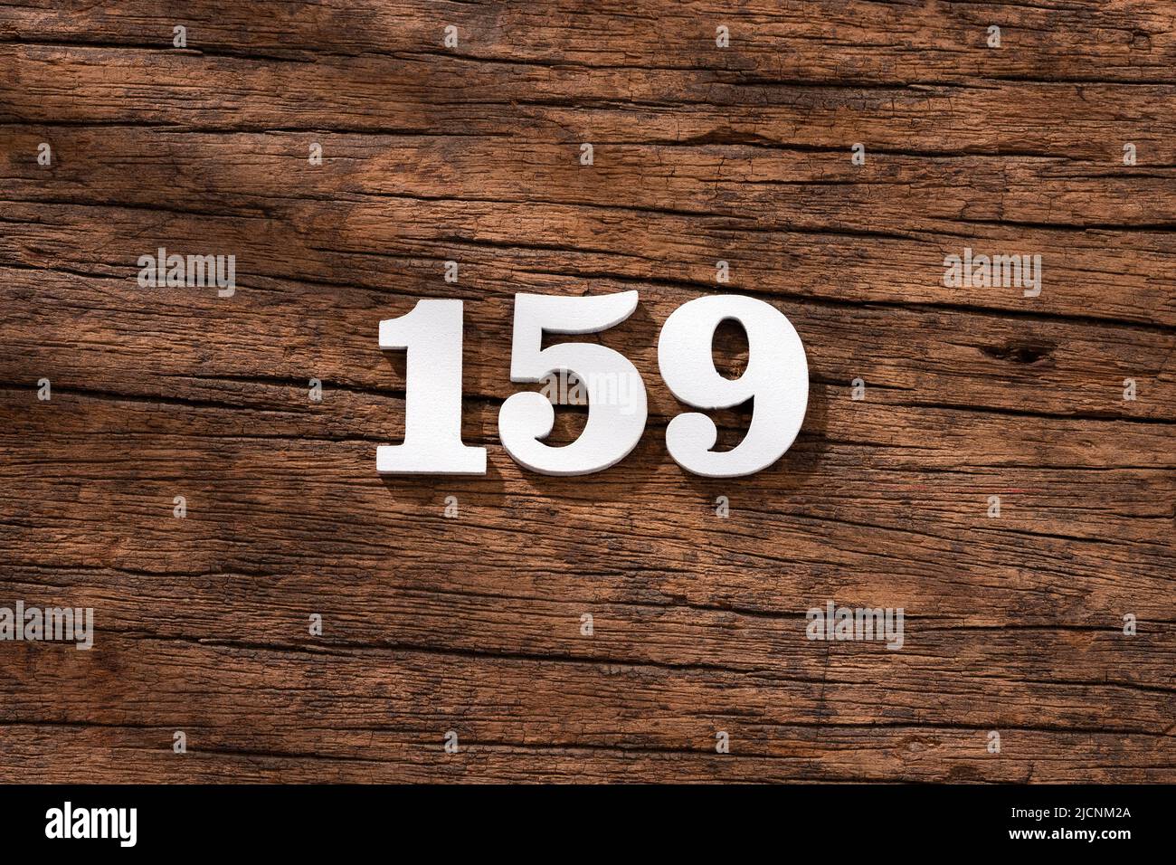 Number 159 - piece on rustic wood background Stock Photo - Alamy