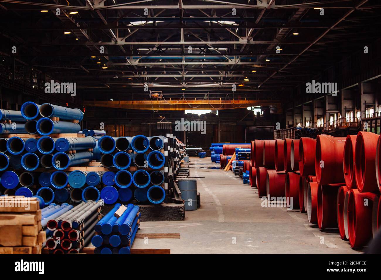 New cast iron pipes for pipeline construction in warehouse Stock Photo ...