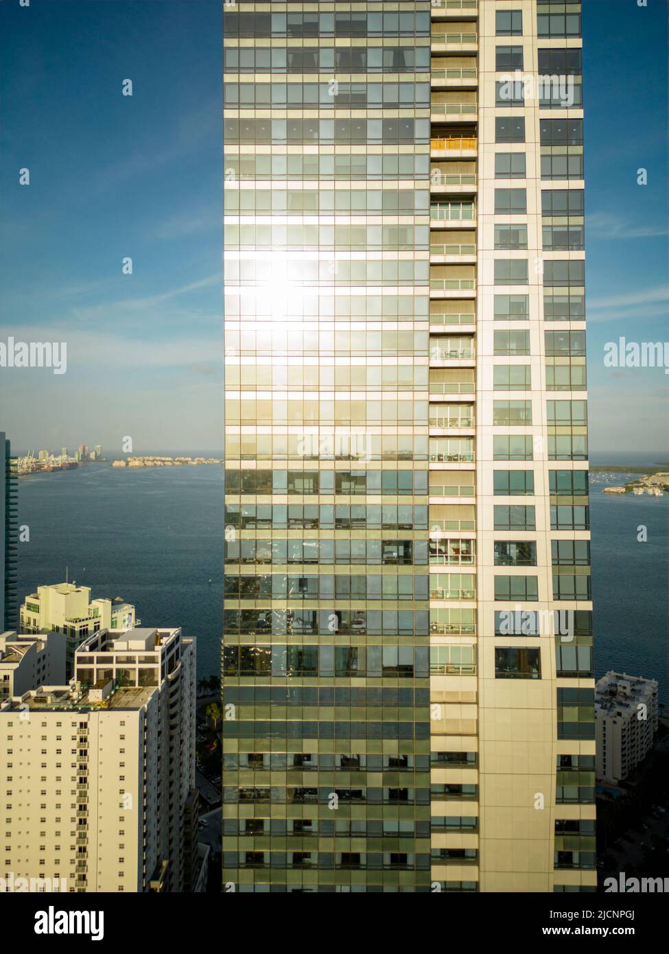 Highrise building with sun reflection in glass Stock Photo - Alamy