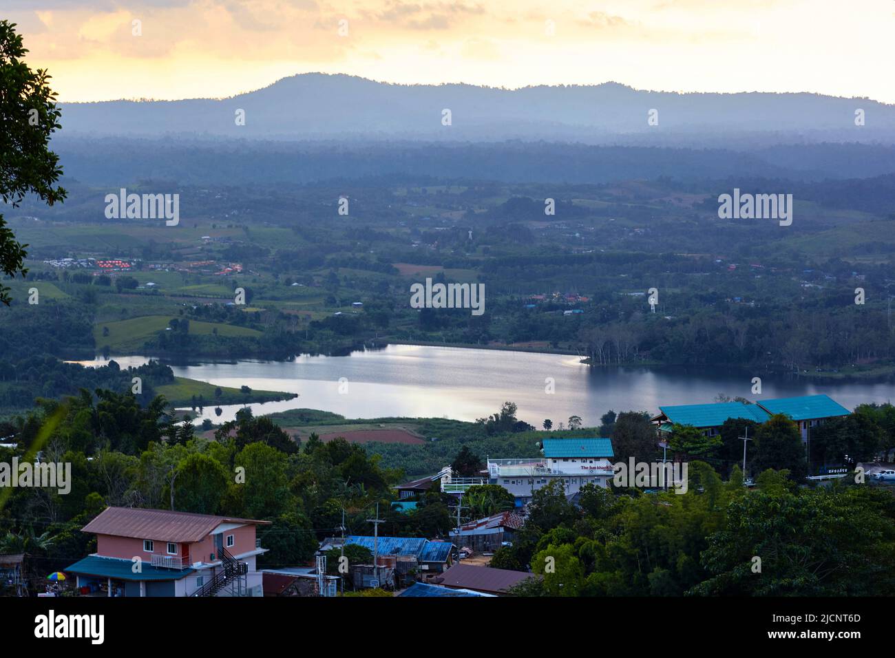 Sunset over the mountain with city in rural scene Stock Photo - Alamy