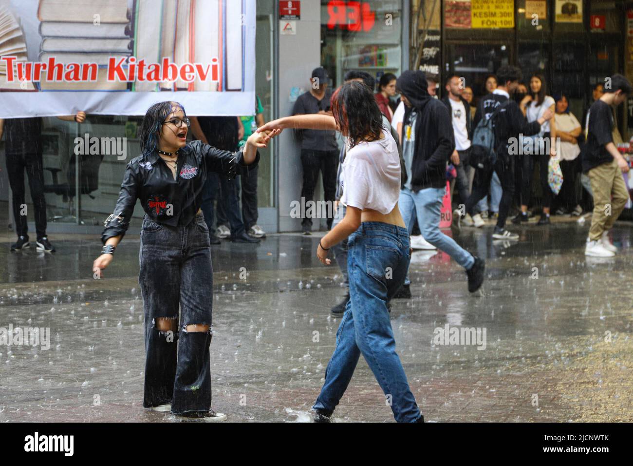 Ankara, Turkey. 14th June, 2022. Women dance in the rain in Ankara ...