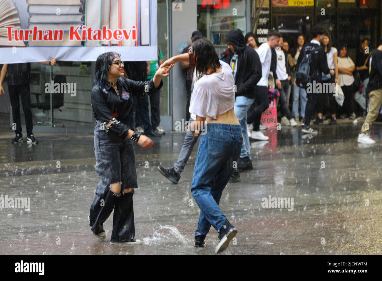 Ankara, Turkey. 14th June, 2022. Women dance in the rain in Ankara ...