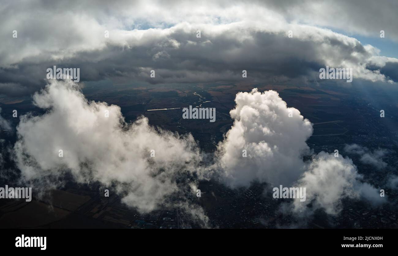 Aerial view from airplane window at high altitude of distant city ...