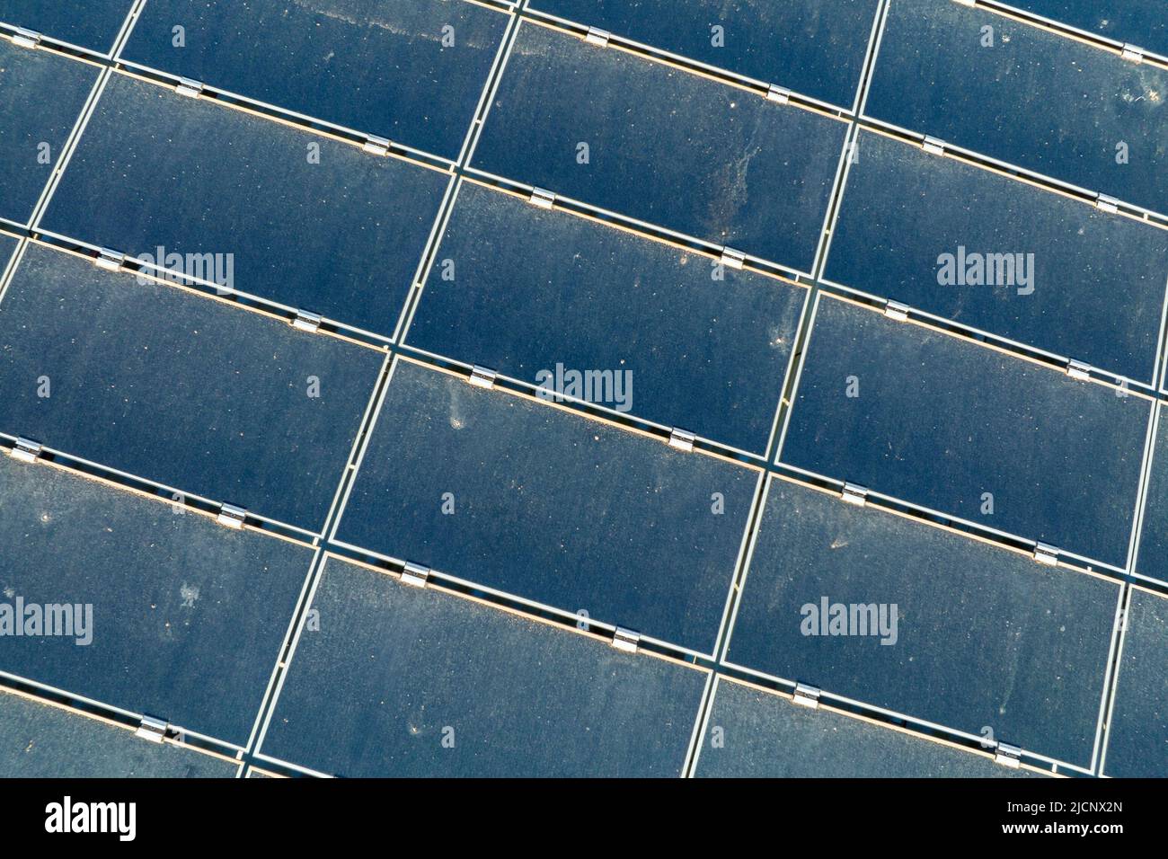 Aerial view of blue photovoltaic solar panels mounted on industrial ...