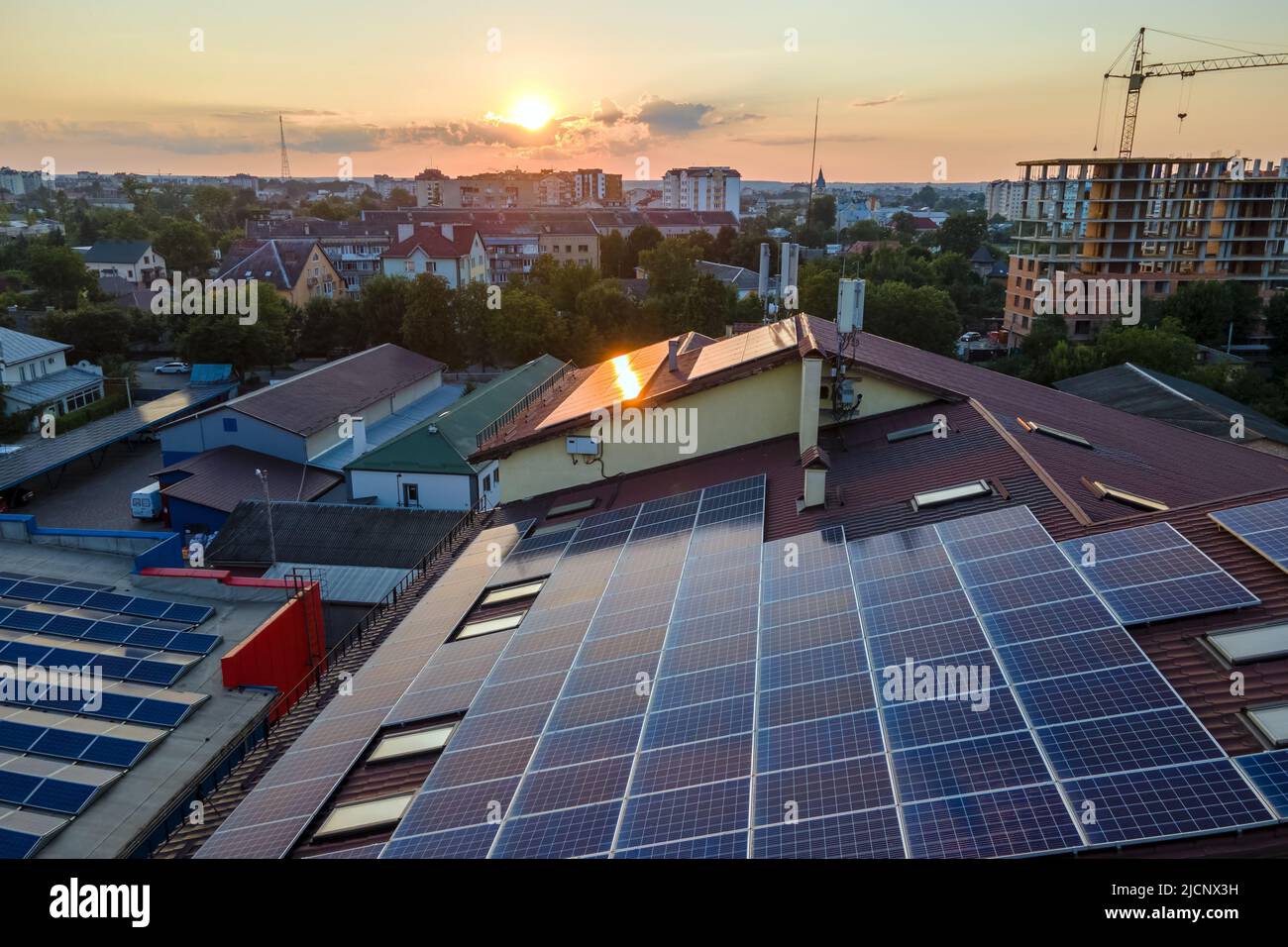 Aerial view of blue photovoltaic solar panels mounted on industrial ...